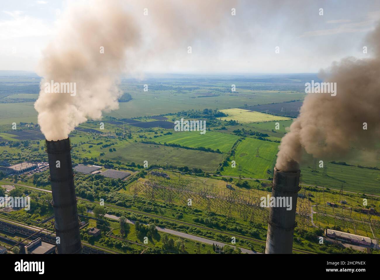 Aerial view of coal power plant high pipes with black smokestack ...