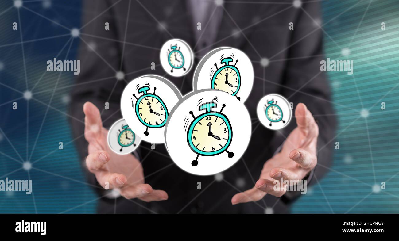 Time concept above the hands of a man in background Stock Photo - Alamy