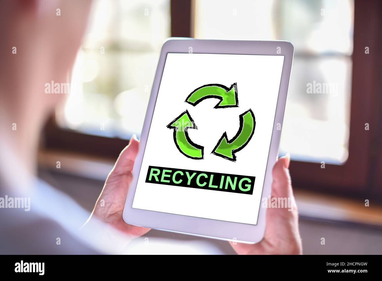 Tablet screen displaying a recycling concept Stock Photo - Alamy