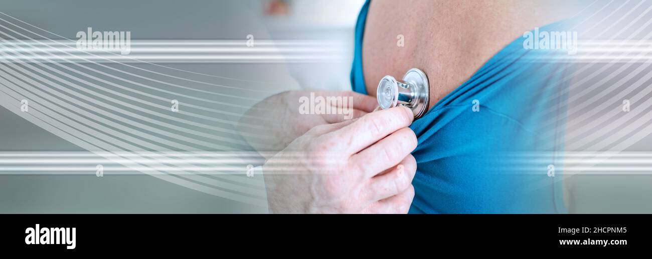 Doctor examining a patient with a stethoscope in his office; panoramic ...