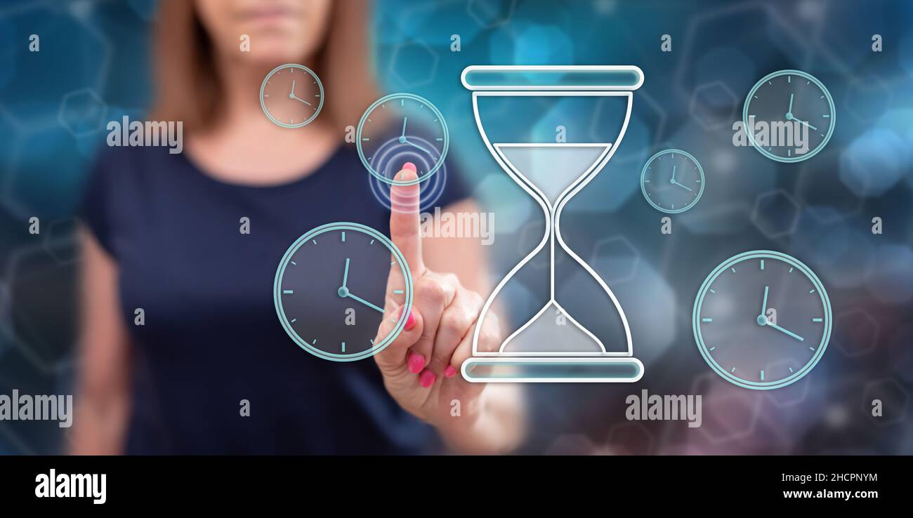 Woman touching a time management concept on a touch screen with her ...