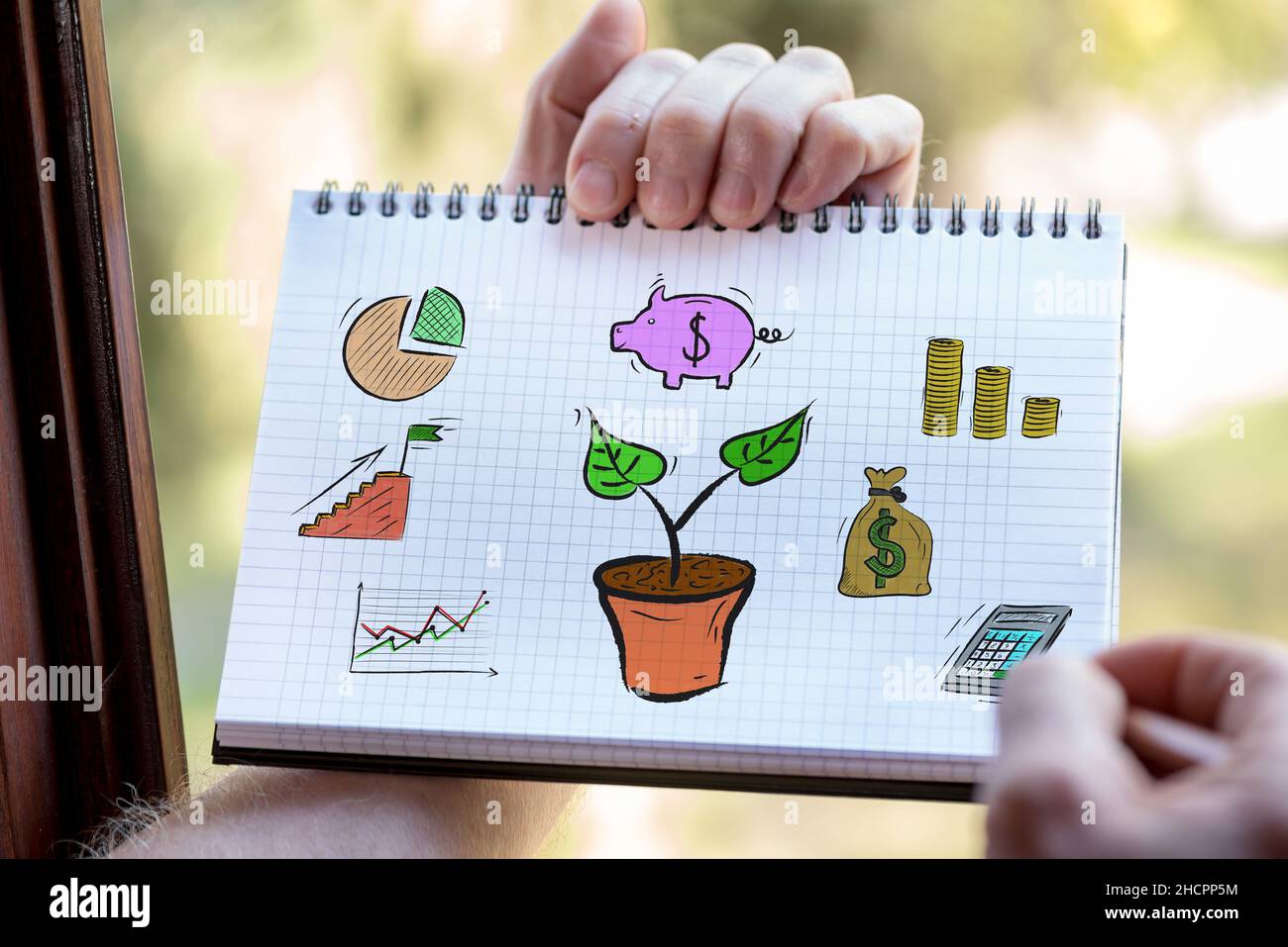 Hand drawing investment concept on a notepad Stock Photo - Alamy