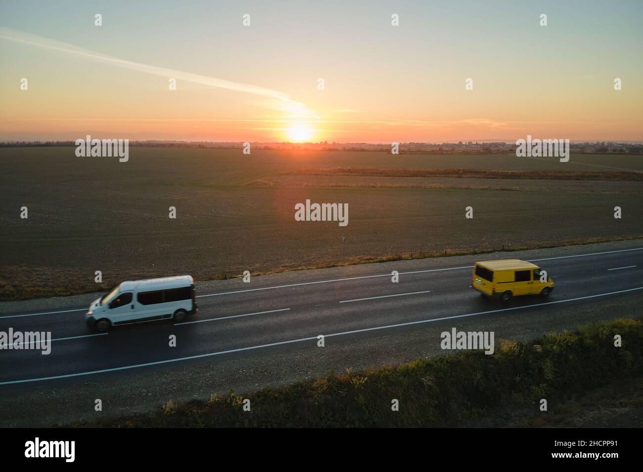 Aerial view of intercity road with fast driving cars at sunset. Top ...