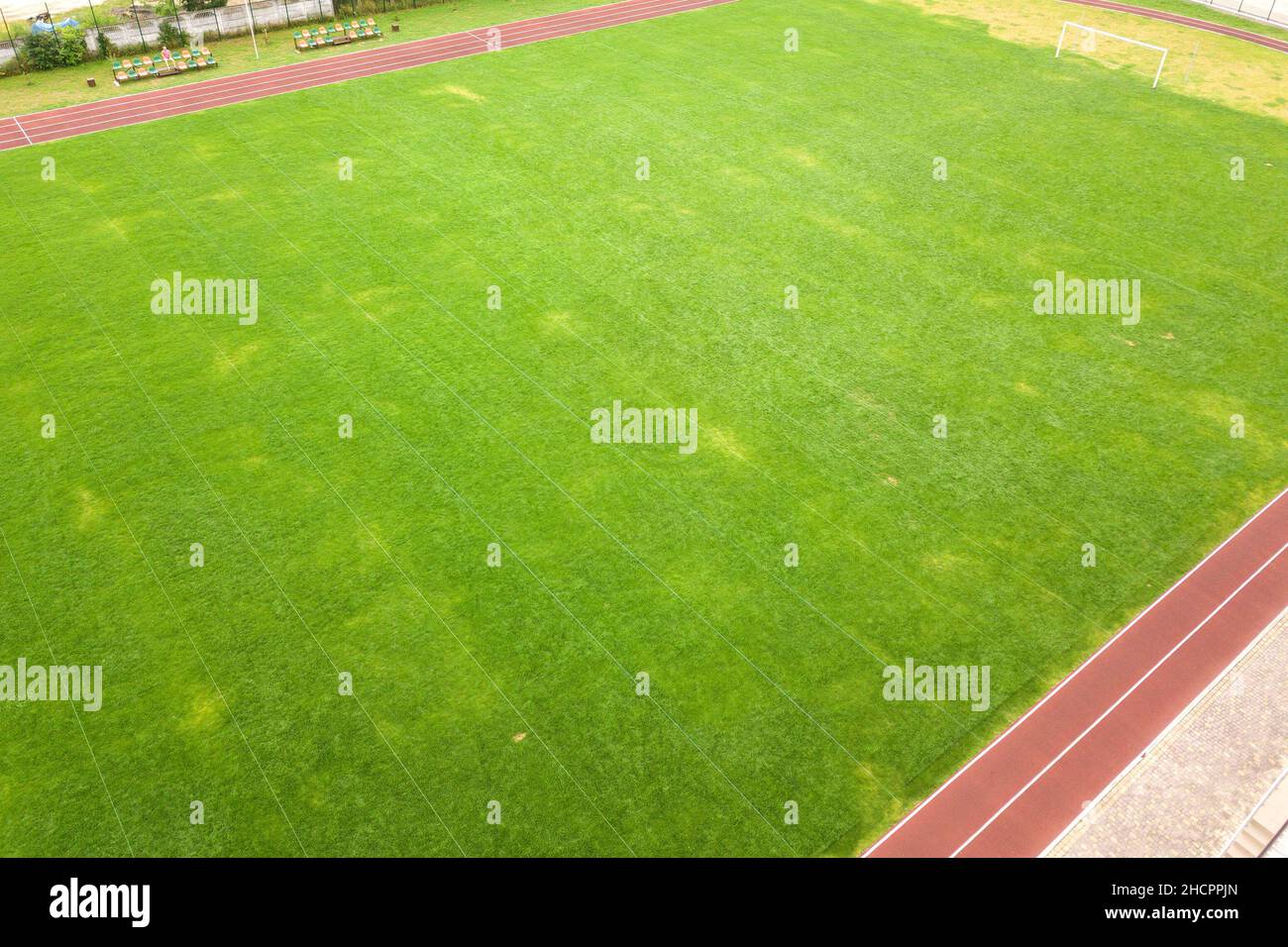 Aerial view of surface of green freshly cut grass on football stadium ...