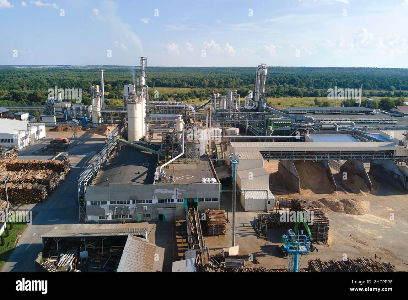 Aerial view of wood processing factory with stacks of lumber at plant ...