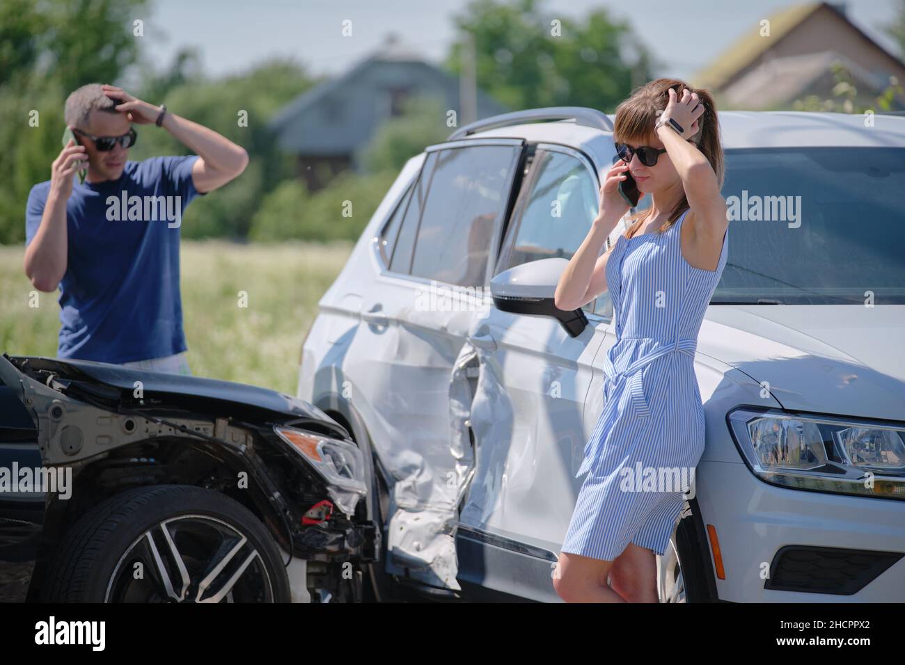Angry woman and man drivers of heavily damaged vehicles calling ...