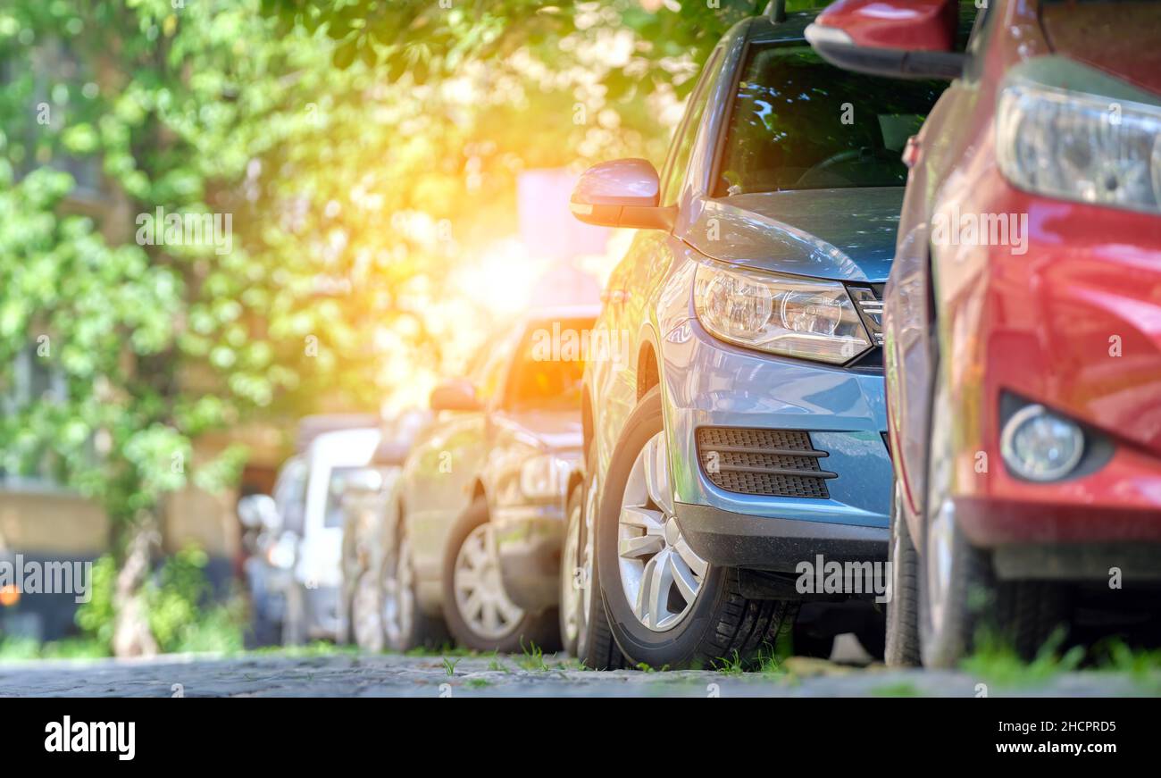 City traffic with cars parked in line on street side Stock Photo - Alamy