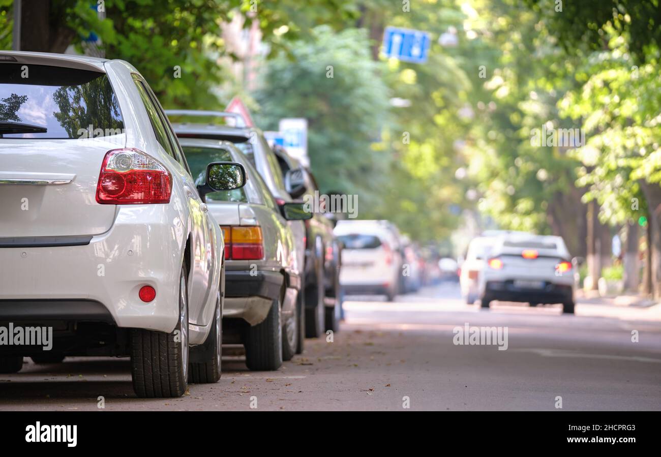 City traffic with cars parked in line on street side Stock Photo - Alamy