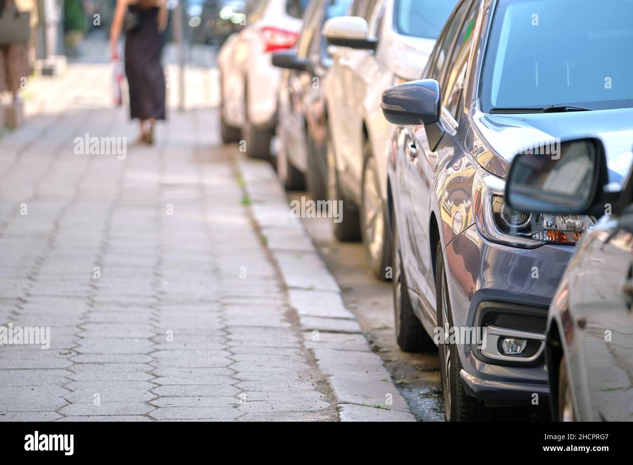 City traffic with cars parked in line on street side Stock Photo - Alamy