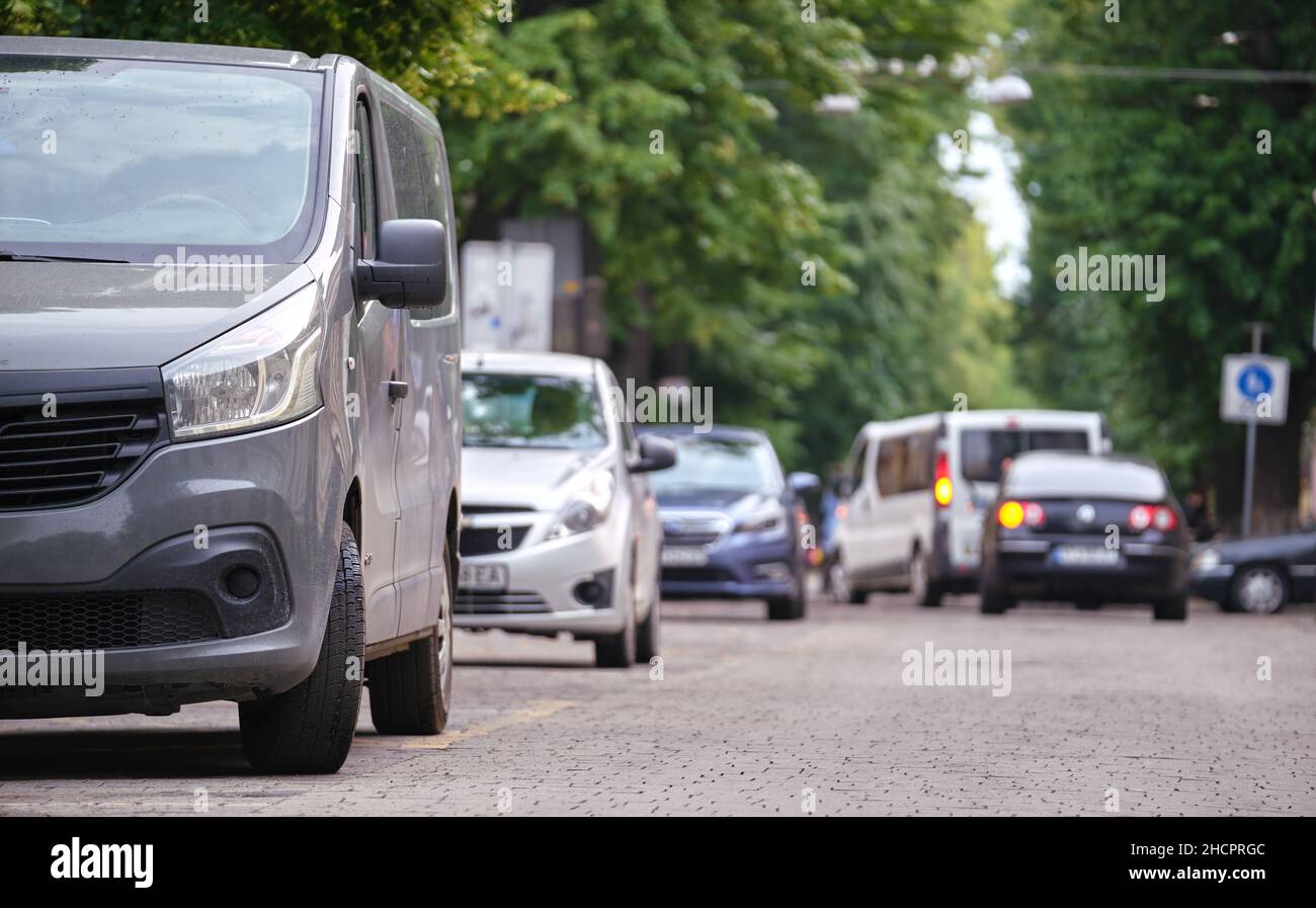 City traffic with cars parked in line on street side Stock Photo - Alamy