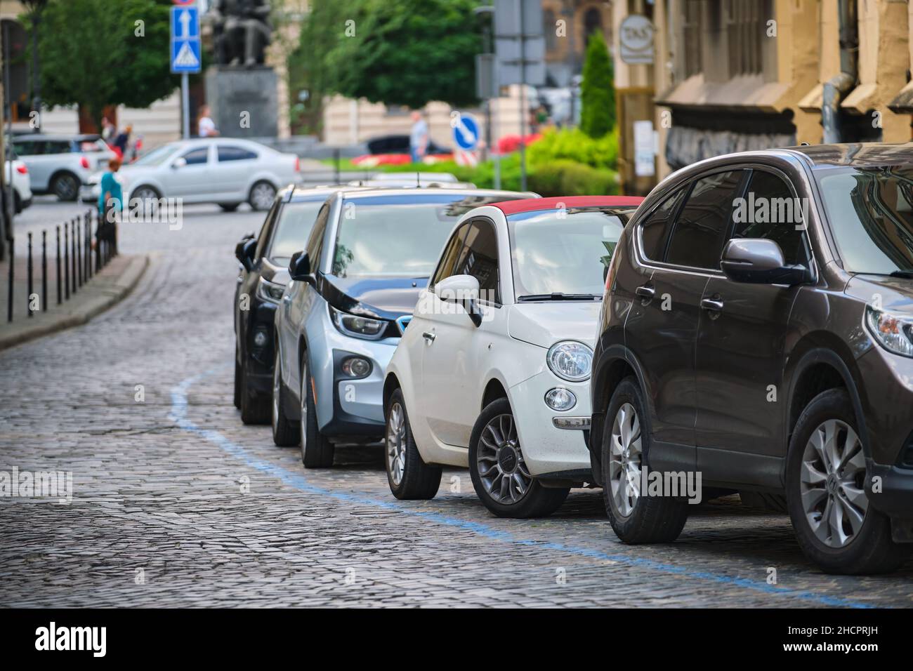 City traffic with cars parked in line on street side Stock Photo - Alamy