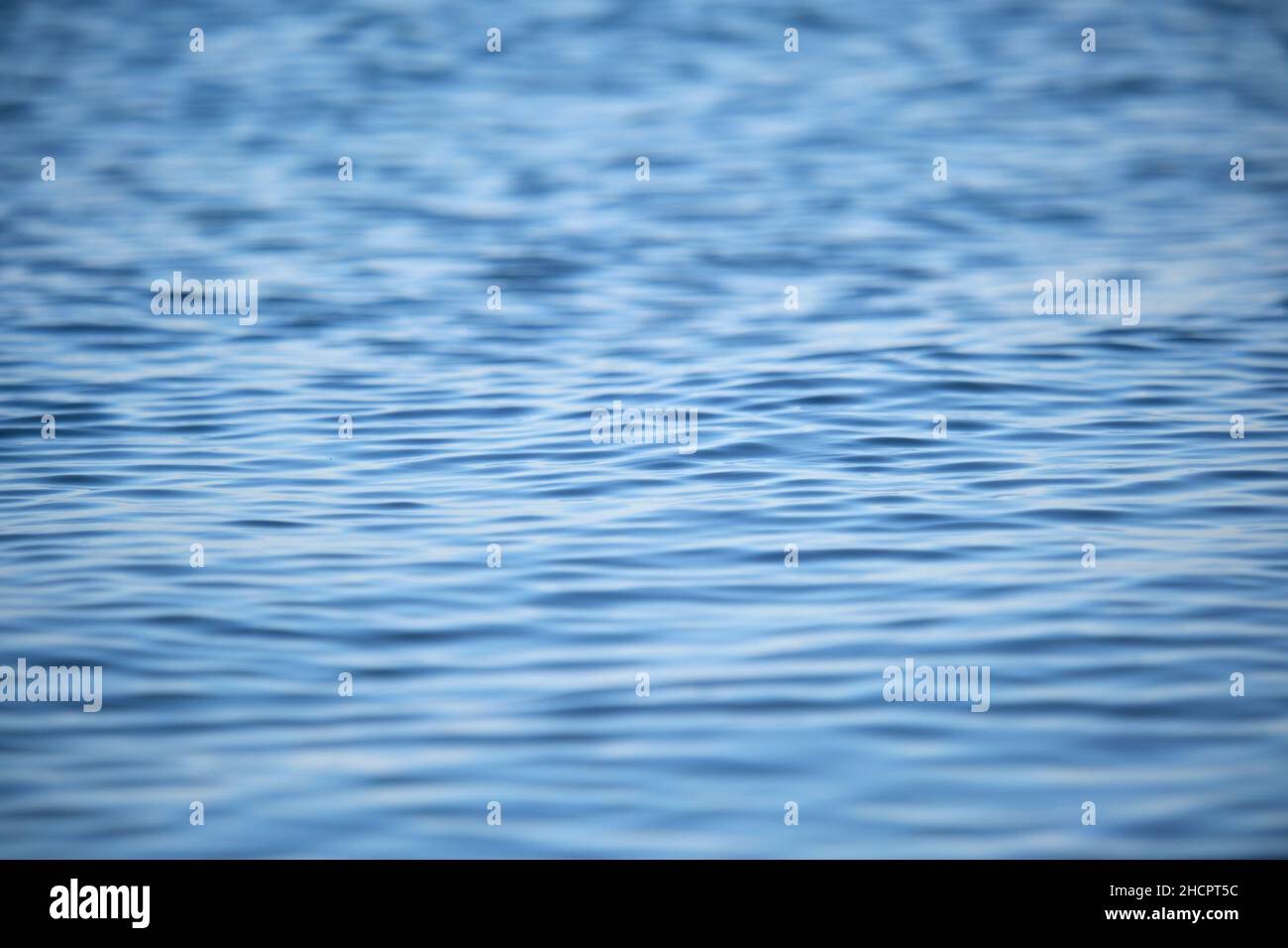 Closeup seascape surface of blue sea water with small ripple waves ...