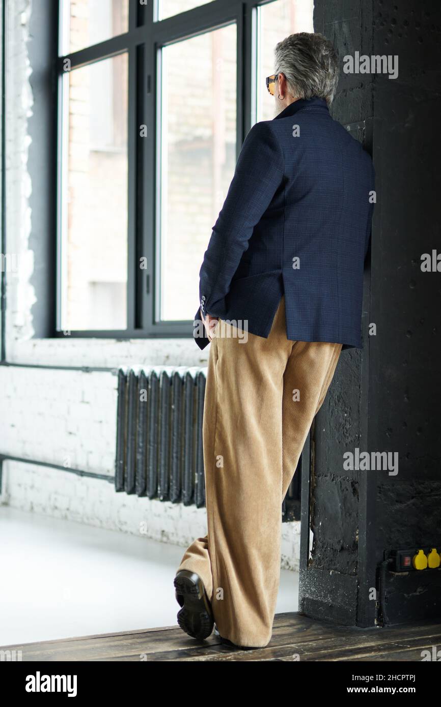 Rear view of stylish middle aged man in business casual wear and ...