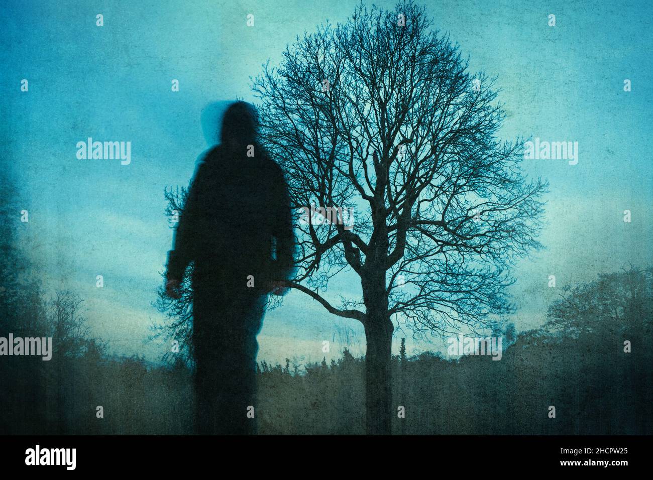 A spooky ghost figure. Walking towards the camera. On a bleak winters ...