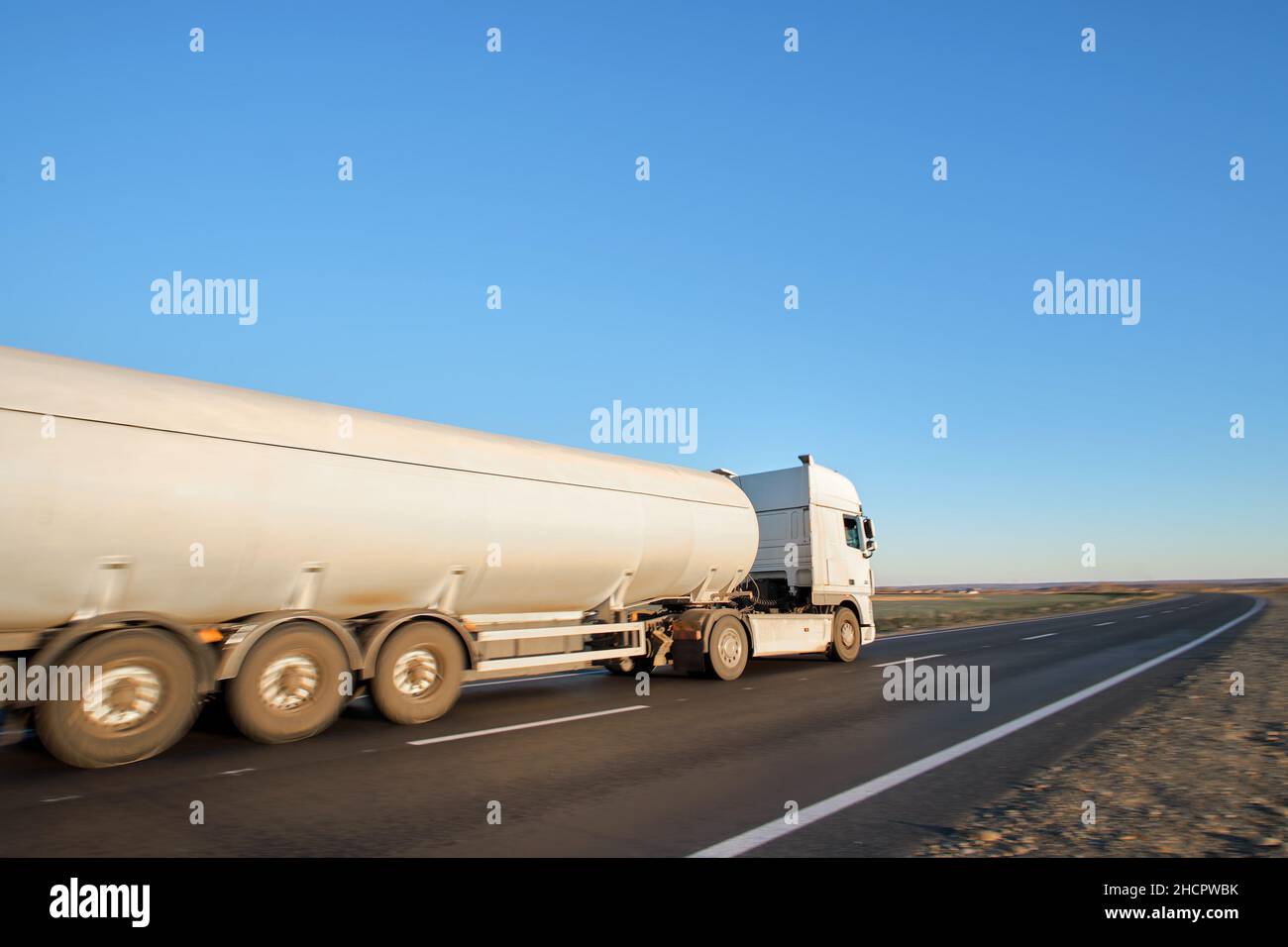Petrol cargo truck driving on highway hauling oil products. Delivery ...