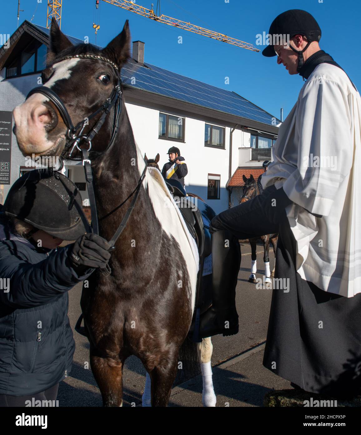 Westhausen, Germany. 31st Dec, 2021. Pastor Matthias Reiner gets on a ...