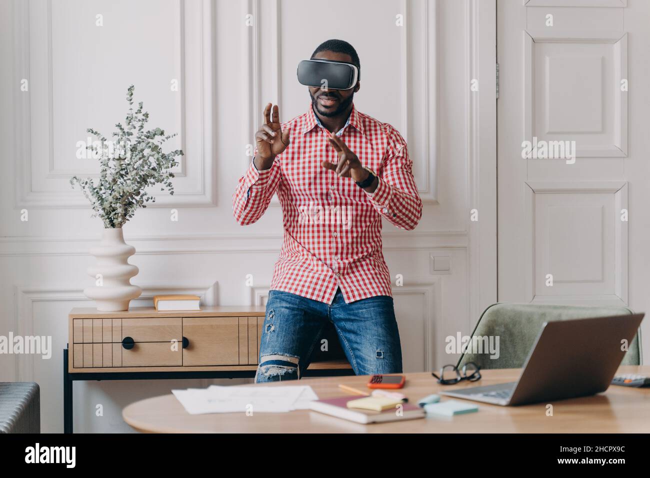 Young programmer or software developer African American man in VR ...