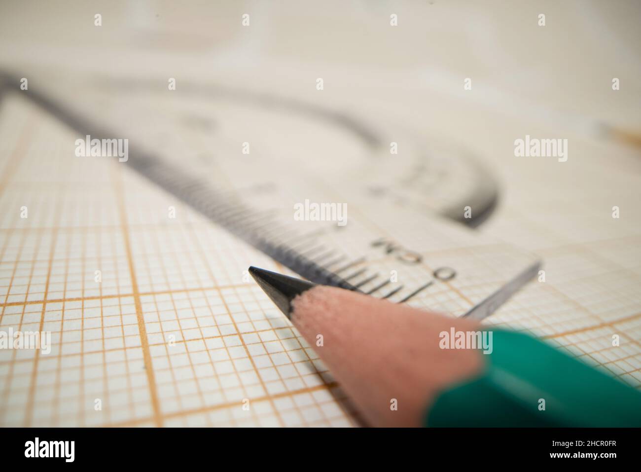 Math concept - macro of a pencil on a piece of paper with geometric ...