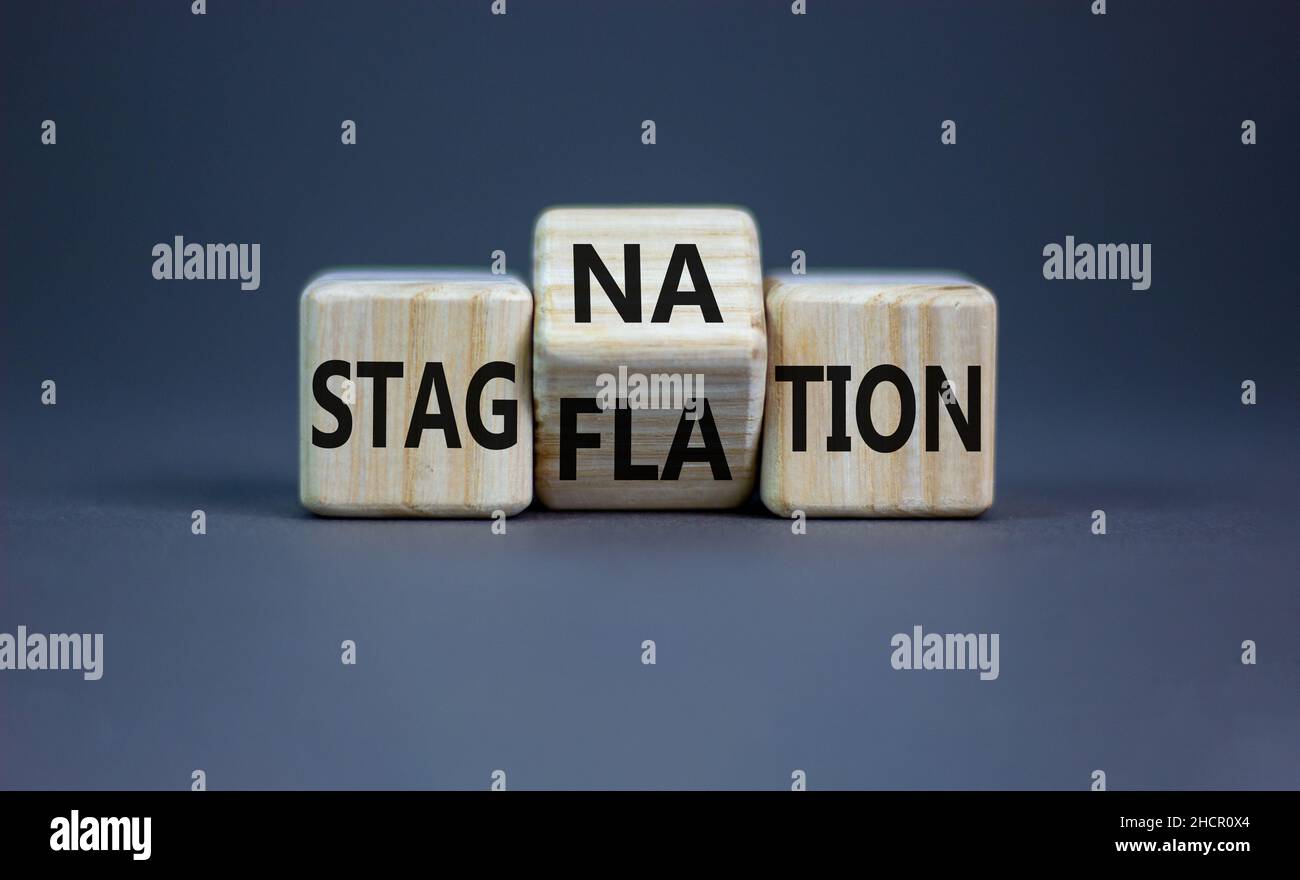 Stagflation or stagnation symbol. Businessman turns cubes, changes the ...