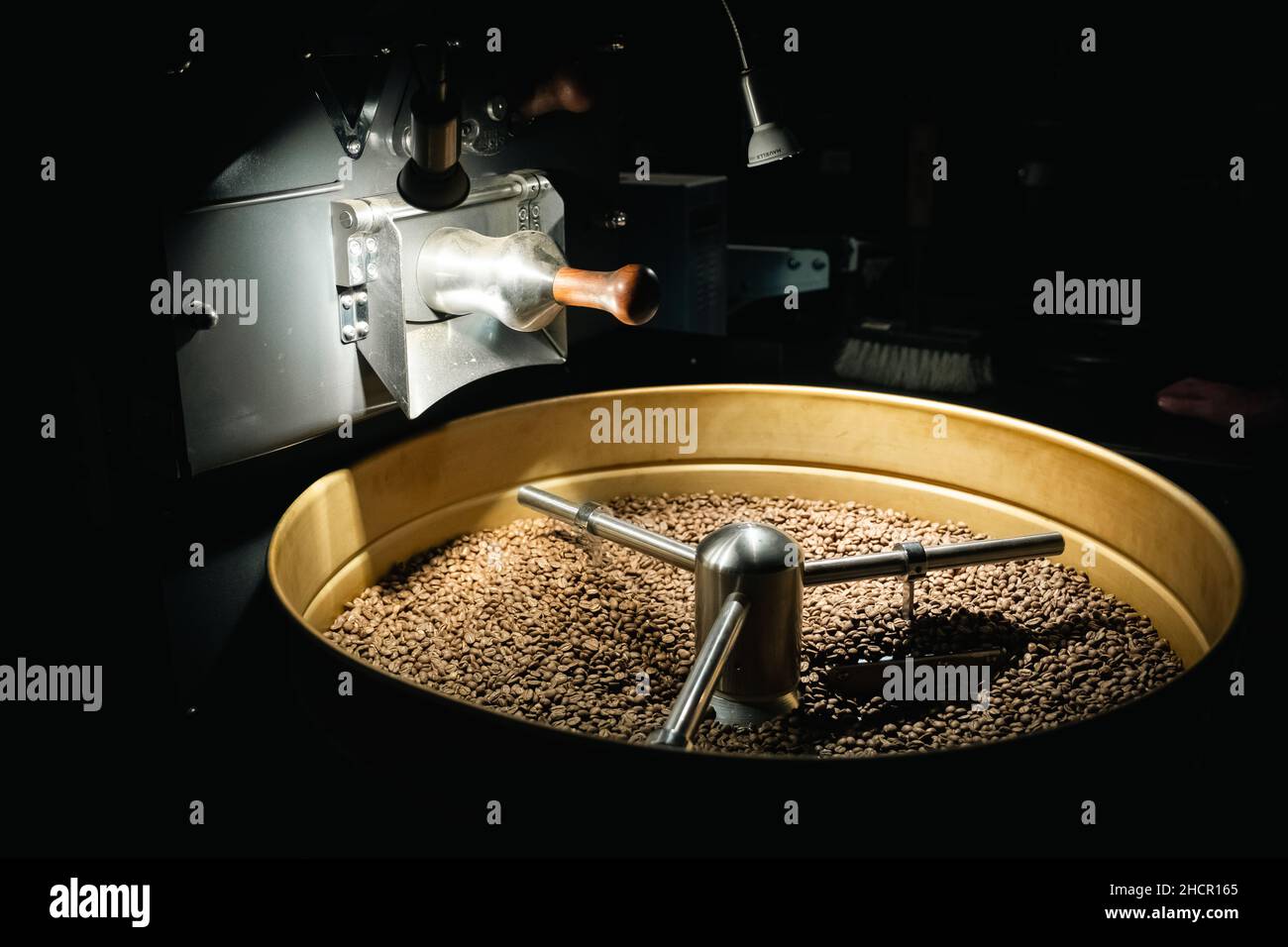 Coffee roaster transforming the properties of green coffee beans into ...