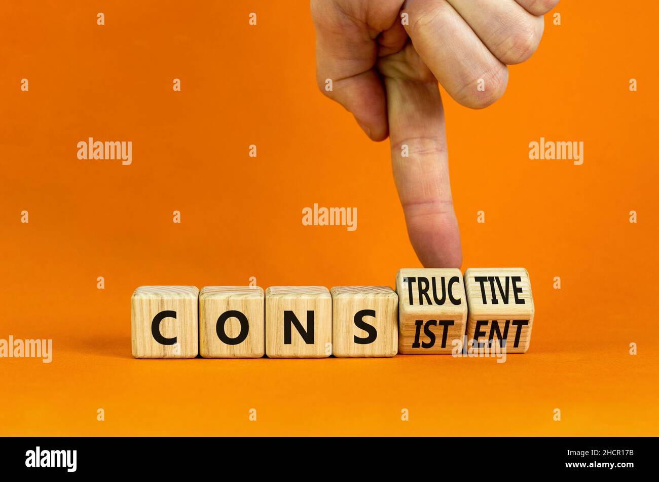 Constructive or consistent symbol. Businessman turns cubes, changes the ...