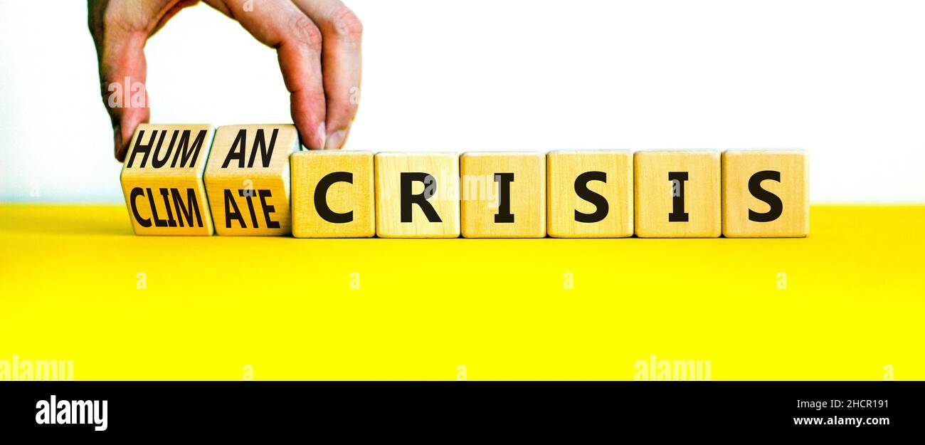 Climate or human crisis symbol. Businessman turns wooden cubes and ...