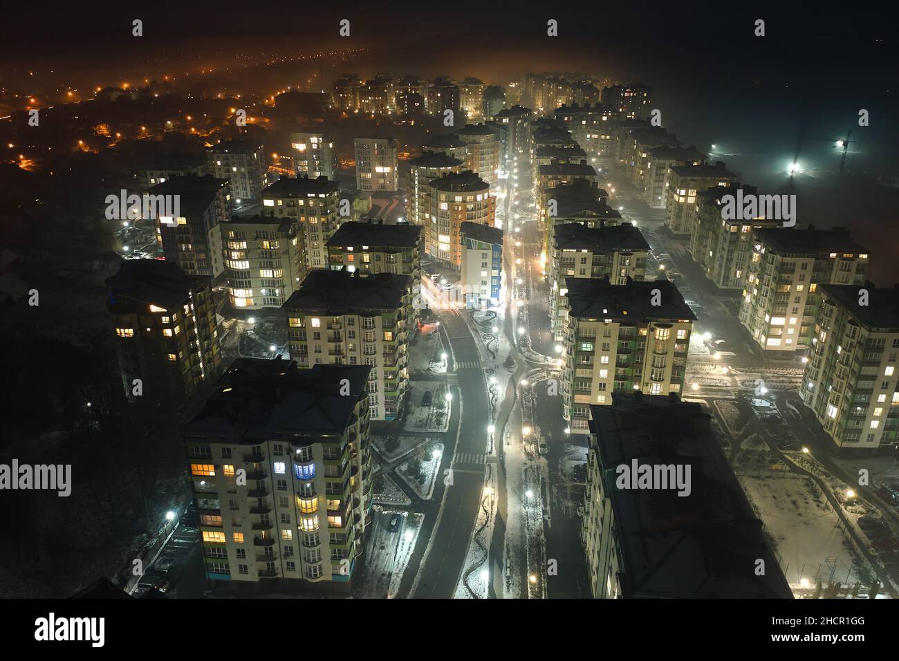 Aerial view of high rise apartment buildings and bright illuminated ...