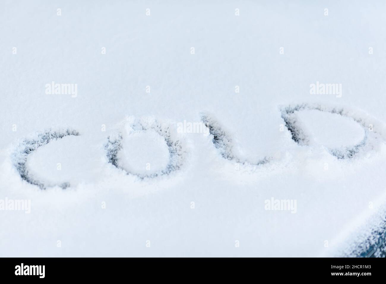 The word cold written on a frozen car screen. Cold written on front ...