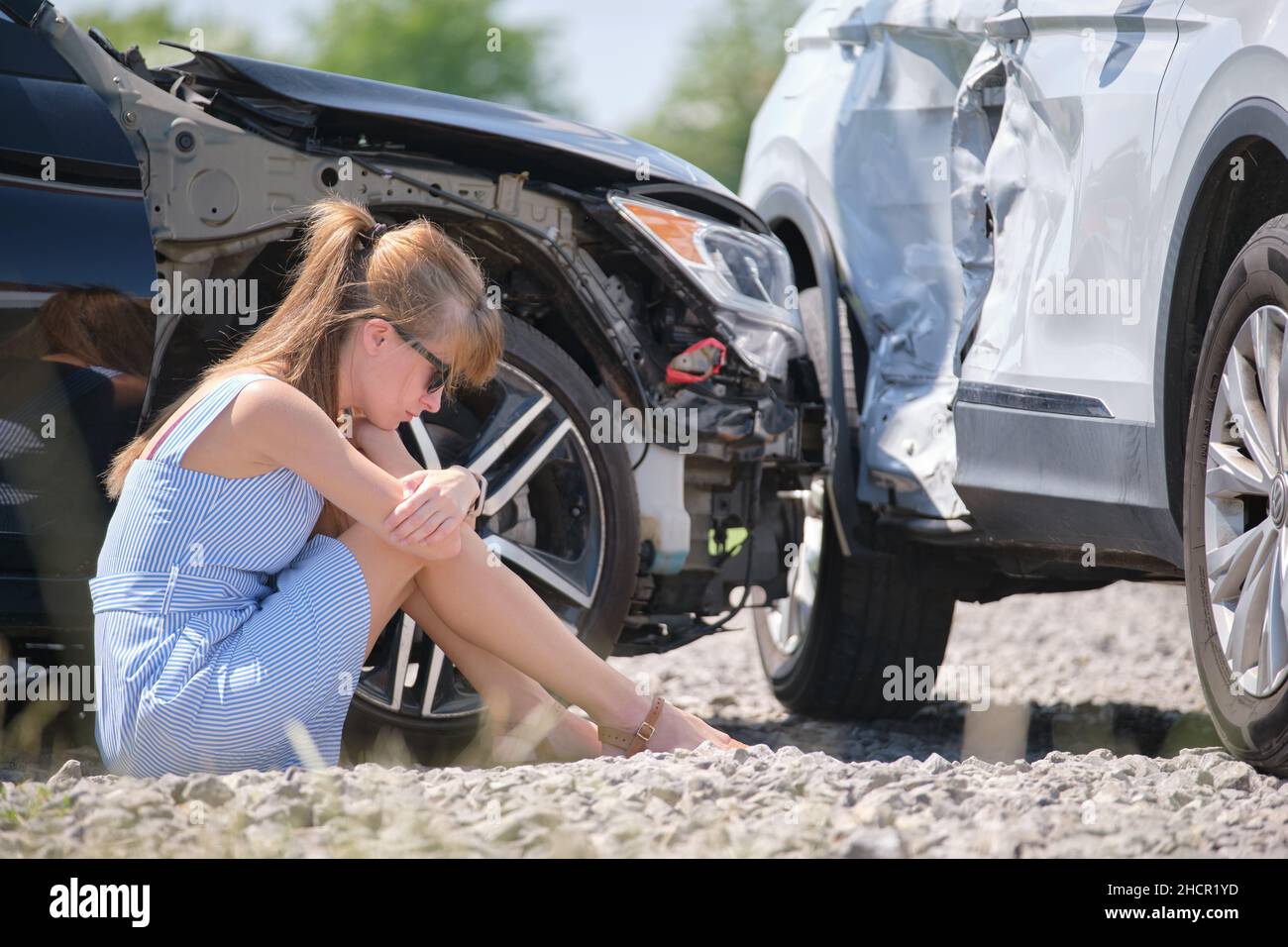 Stressed woman driver sitting on street side shocked after car accident ...