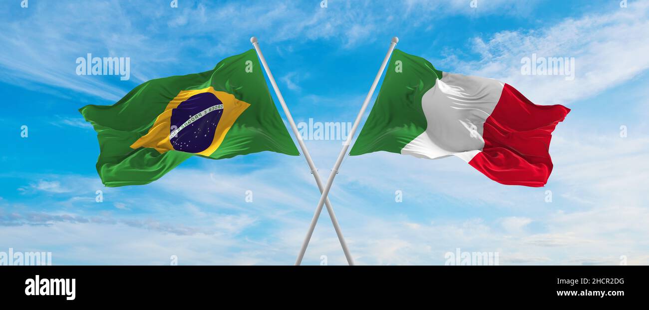 crossed national flags of Brazil and Italia flag waving in the wind at ...