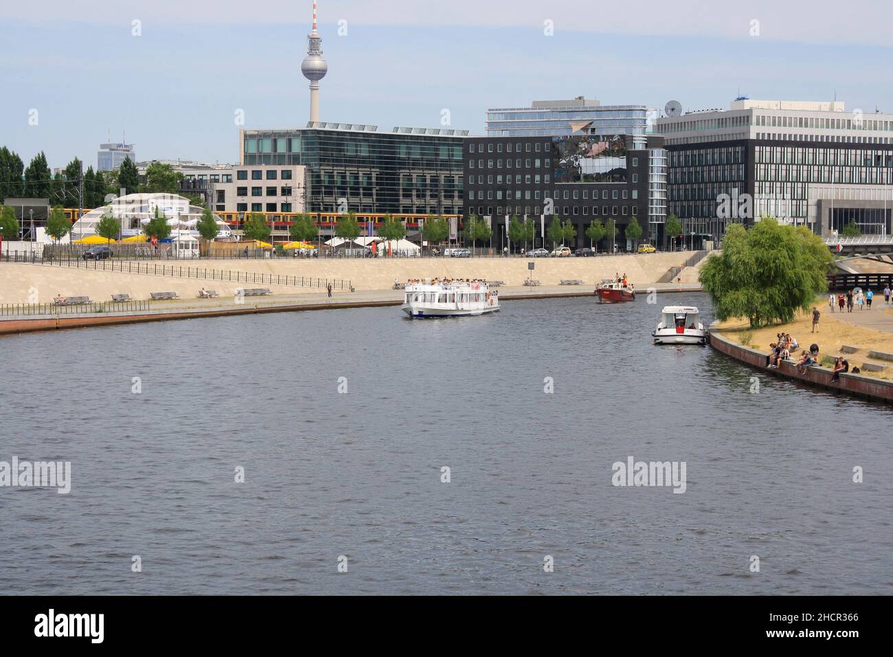 View of Spree River on sunny summer with city sightseeing tour cruise ...
