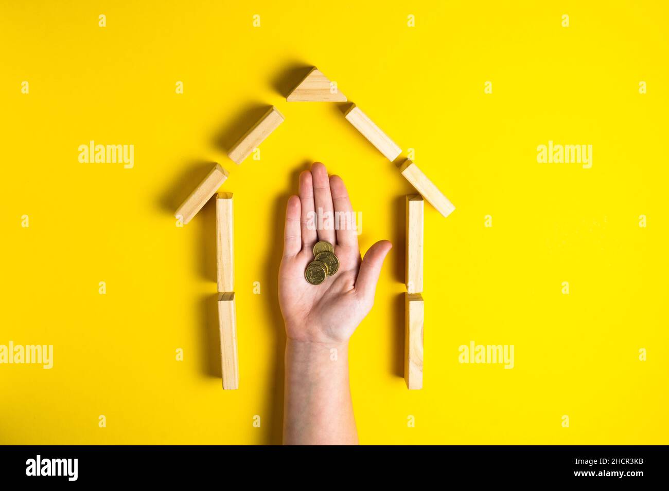 Top view of child's hand close up build blocks showing mince money ...