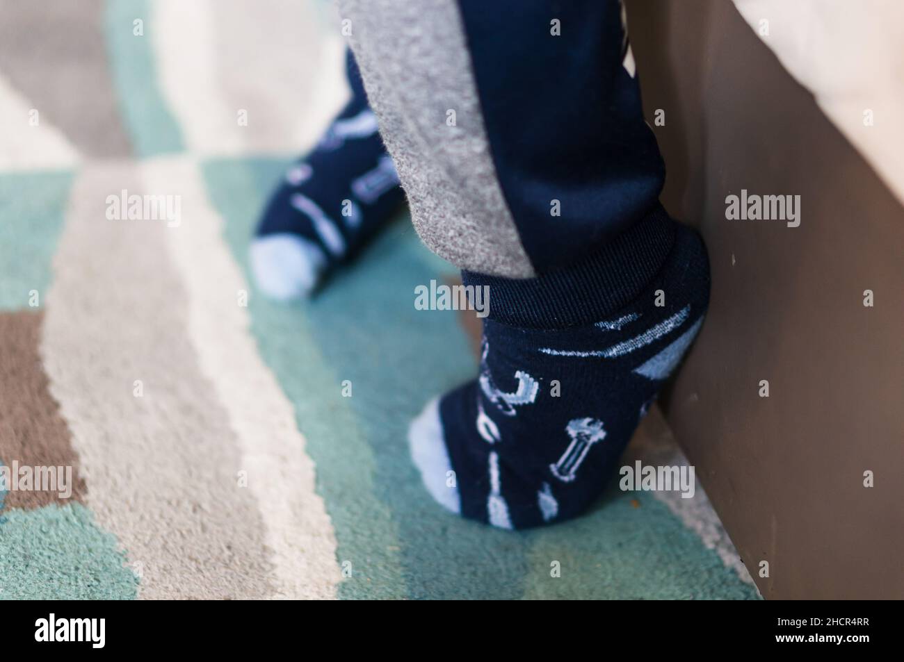 Closeup of young child feet wearing socks Stock Photo - Alamy