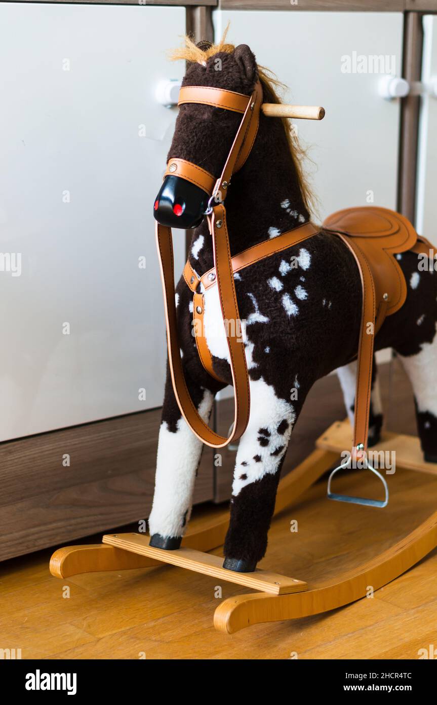 Cute rocking horse for a child near the wardrobe Stock Photo - Alamy