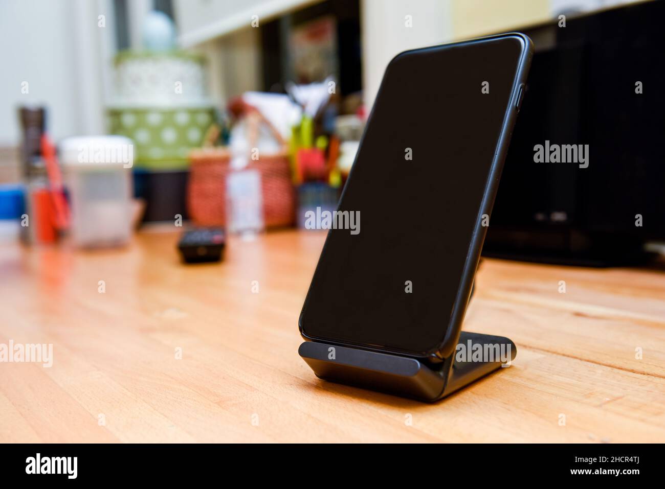 Mobile cell phone charging on wireless charger in home interior Stock ...