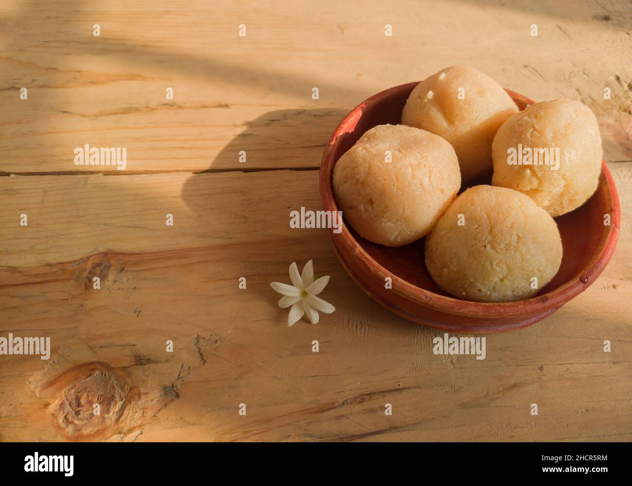 nolen gur rosogolla or rasgulla served on plate. brown spongy bengali ...
