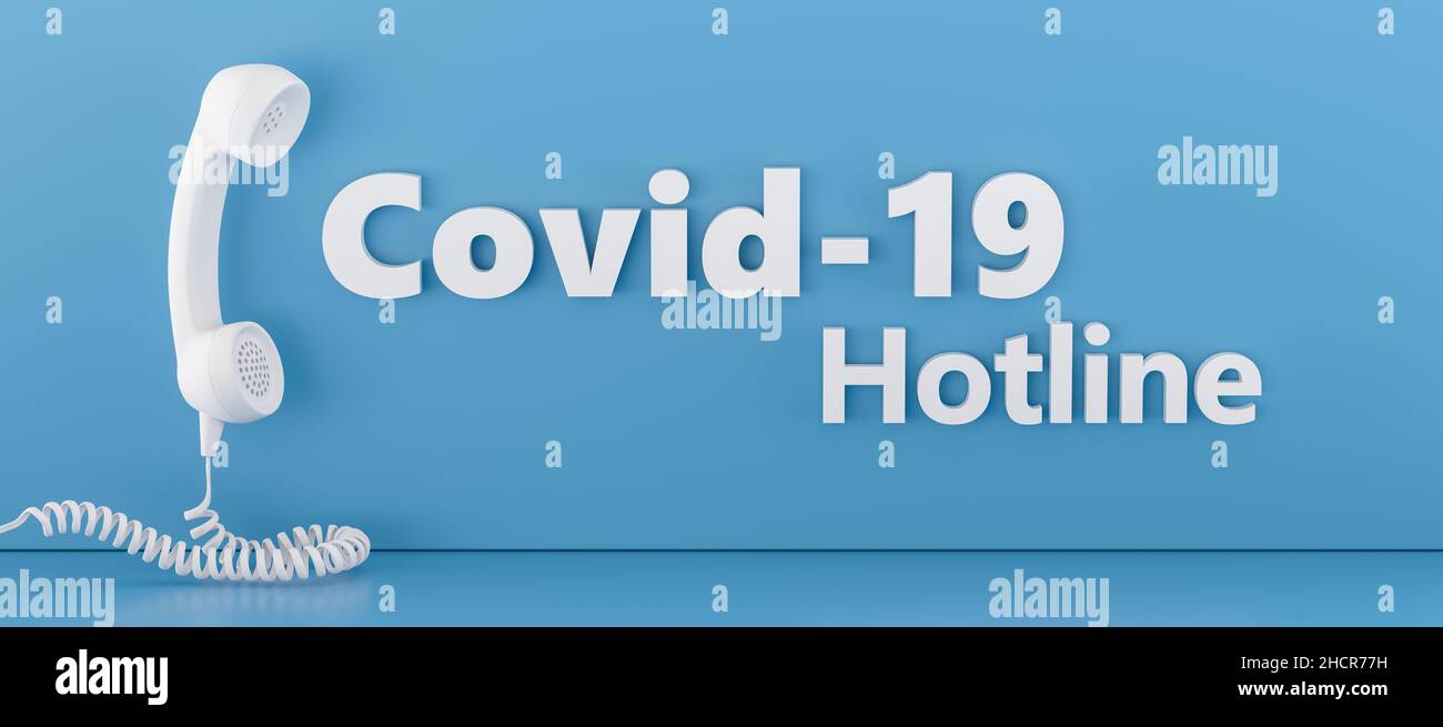 Hotline Landline telephone in front of a color wall background. Corona ...