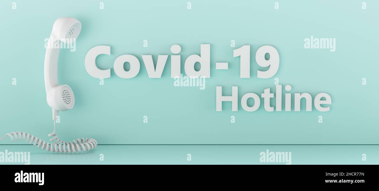 Hotline Landline telephone in front of a color wall background. Corona ...