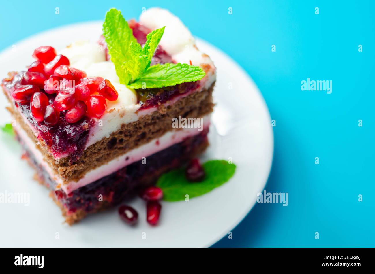 Colorful multi-layered cream chocolate cake with cherry jam and ...
