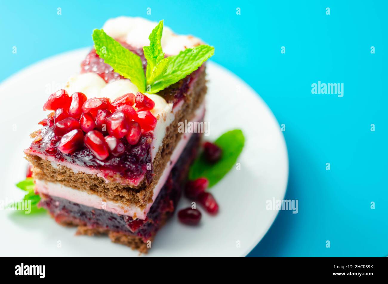 Colorful multi-layered cream chocolate cake with cherry jam and ...