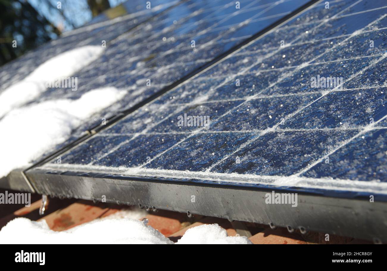 Solar panels covered by frozen ice and snow. Photovoltaic electricity ...