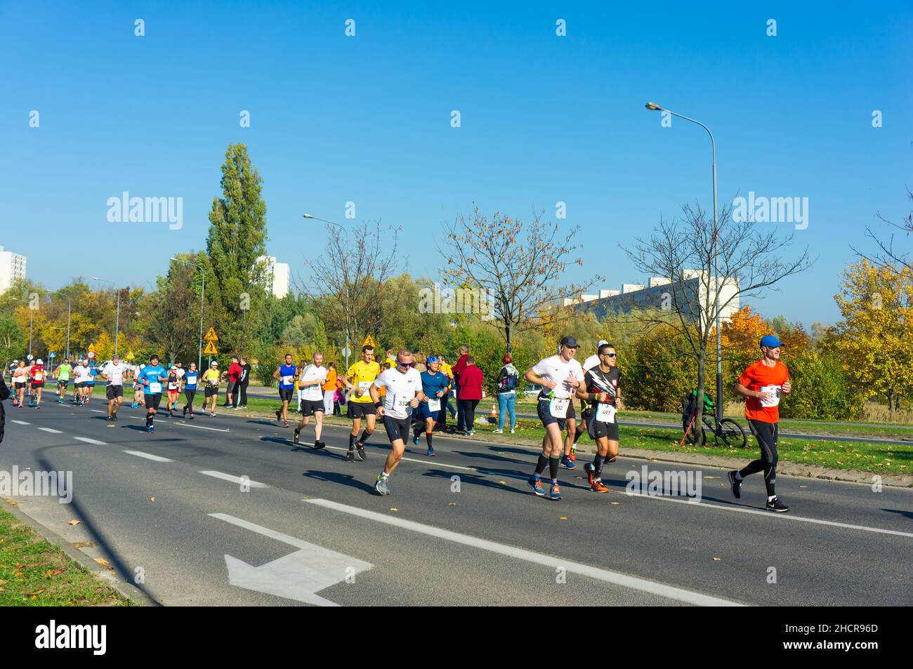 Beautiful shot of people running for charity on an asphalt road in ...