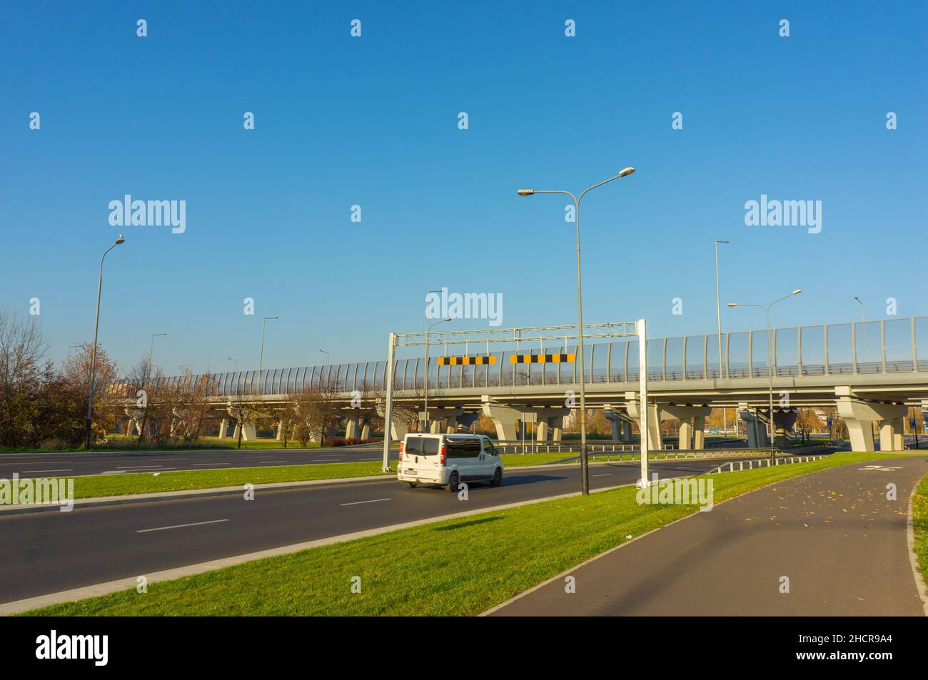 Asphalt road with driving car leading to a bridge Stock Photo - Alamy