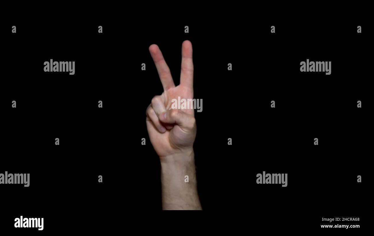 Hand showing victory sing on black background. hand peace or victory ...