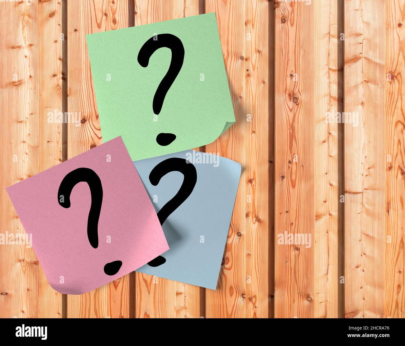 Sticky notes with question marks on a wooden wall Stock Photo - Alamy