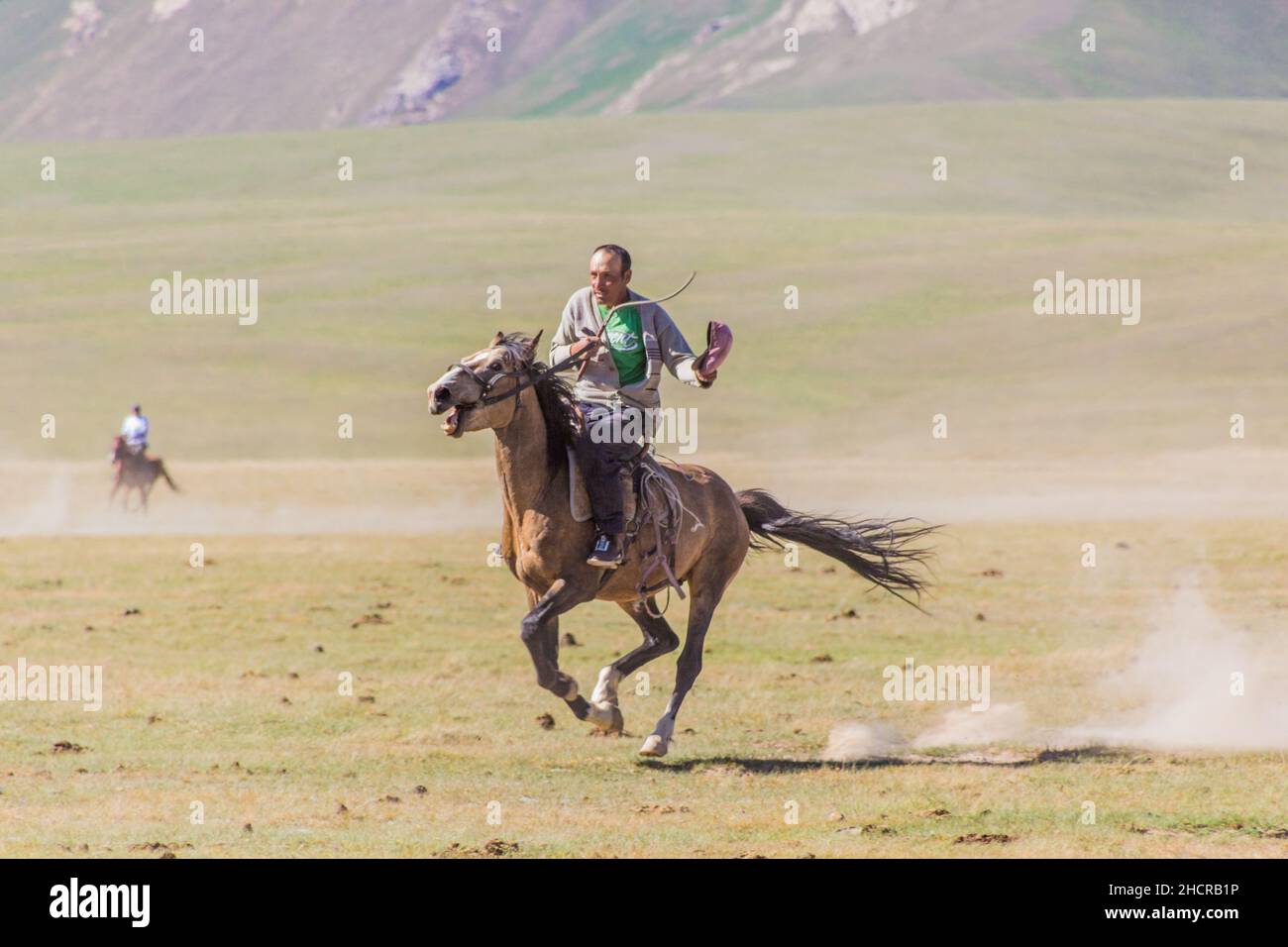 SONG KOL, KYRGYZSTAN - JULY 25, 2018: Kyrgyz horse riders at the shores ...