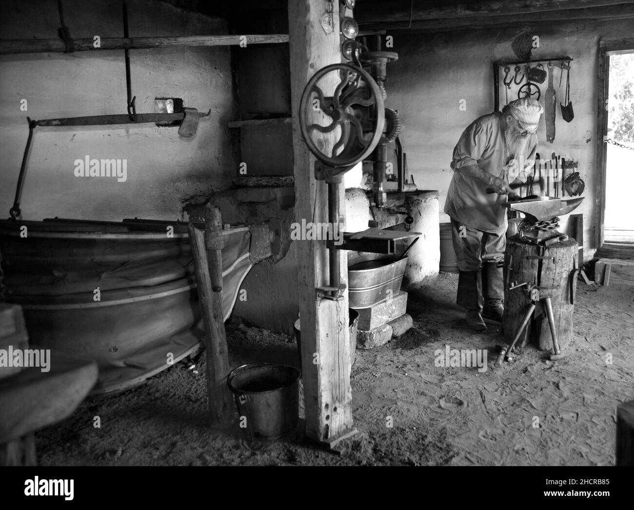 A blacksmith demonstrates his trade in the blacksmith shop at El Rancho ...
