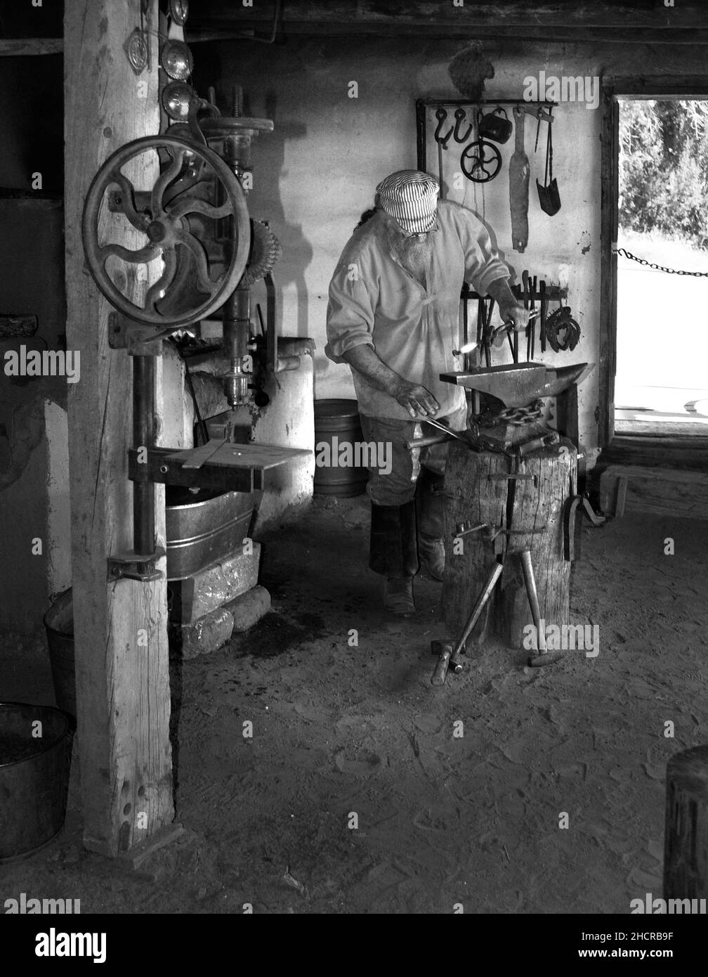 A blacksmith demonstrates his trade in the blacksmith shop at El Rancho ...