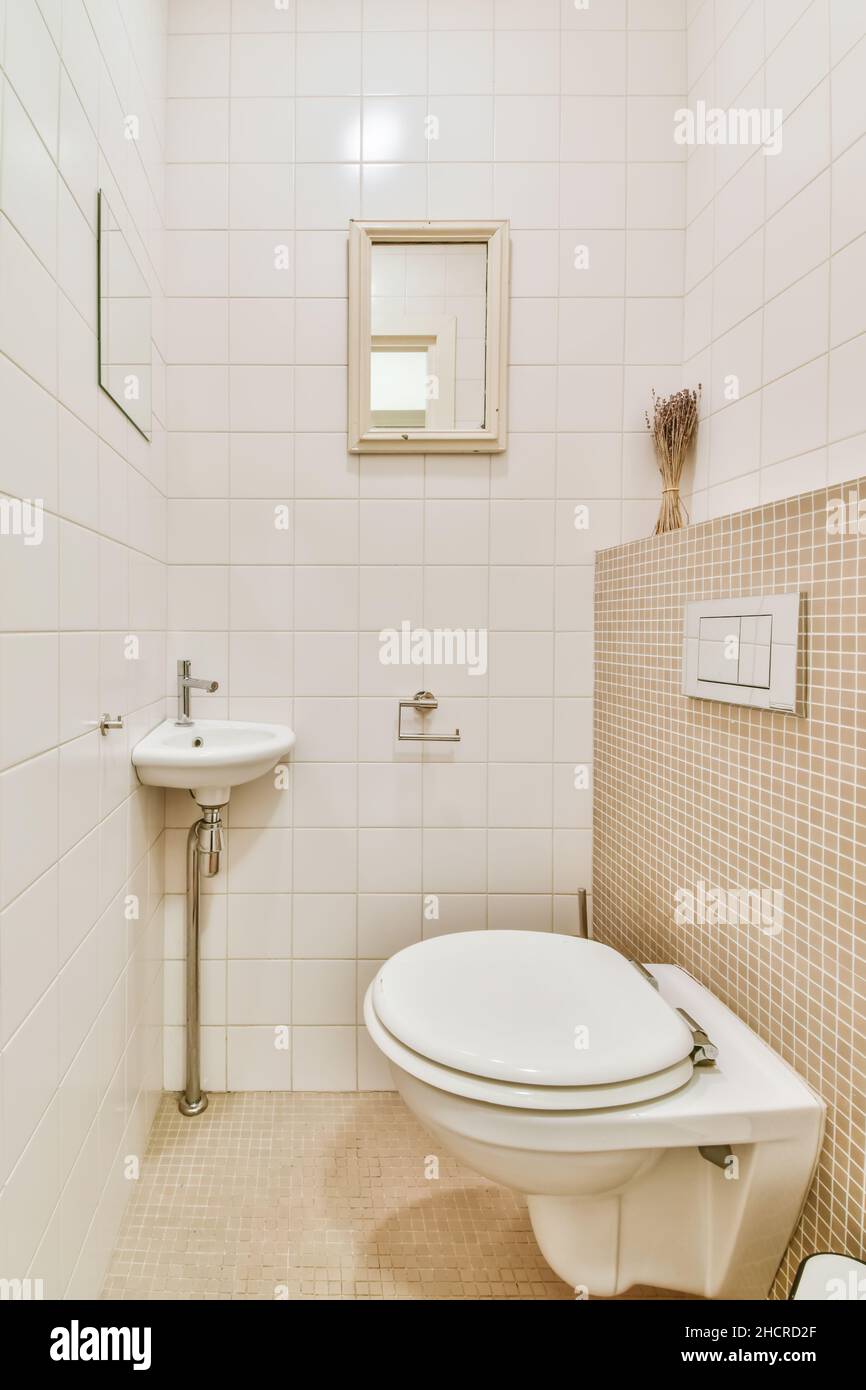 Interior of small clean restroom in miniature style Stock Photo - Alamy