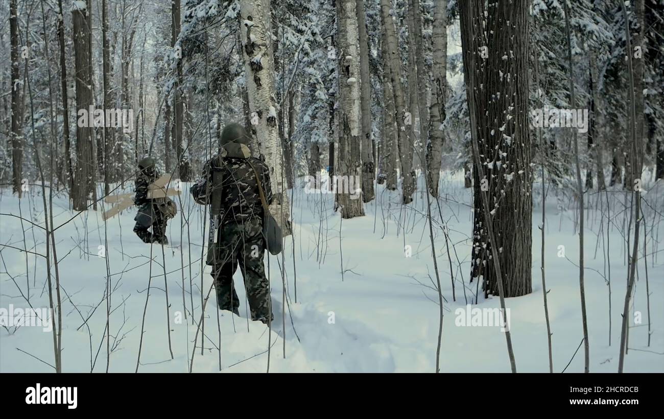 Soldier with weapons in cold forest. Winter warfare and military ...